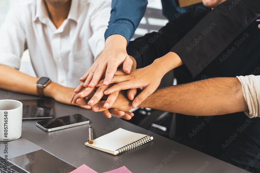 Group of diverse office worker join hand together in office room ...