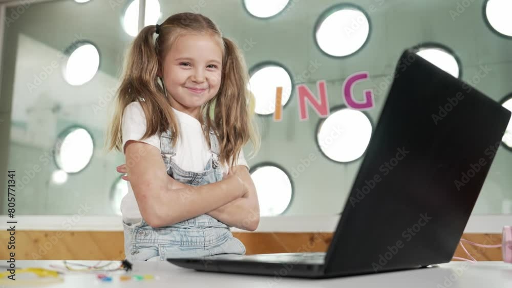 Cute Girl Using Laptop Programing Software While Looking At Camera With