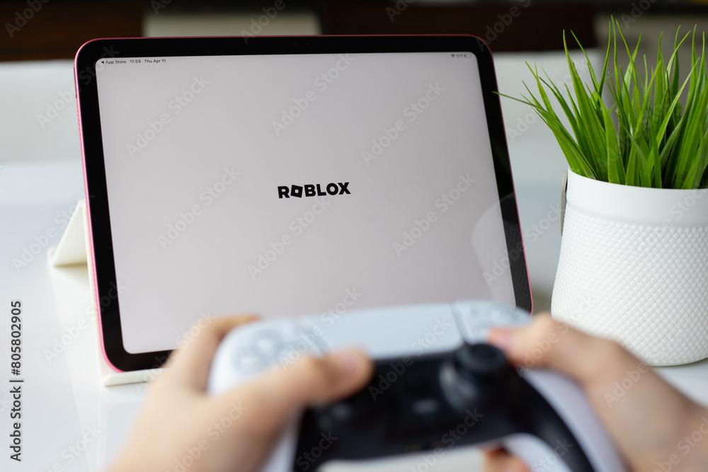 Children hands DualSense controller PlayStation Apple iPad with games ...