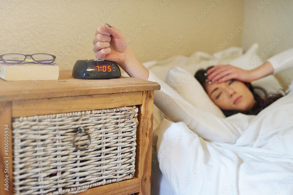 Home, alarm and woman wake up with headache, sick or morning insomnia ...