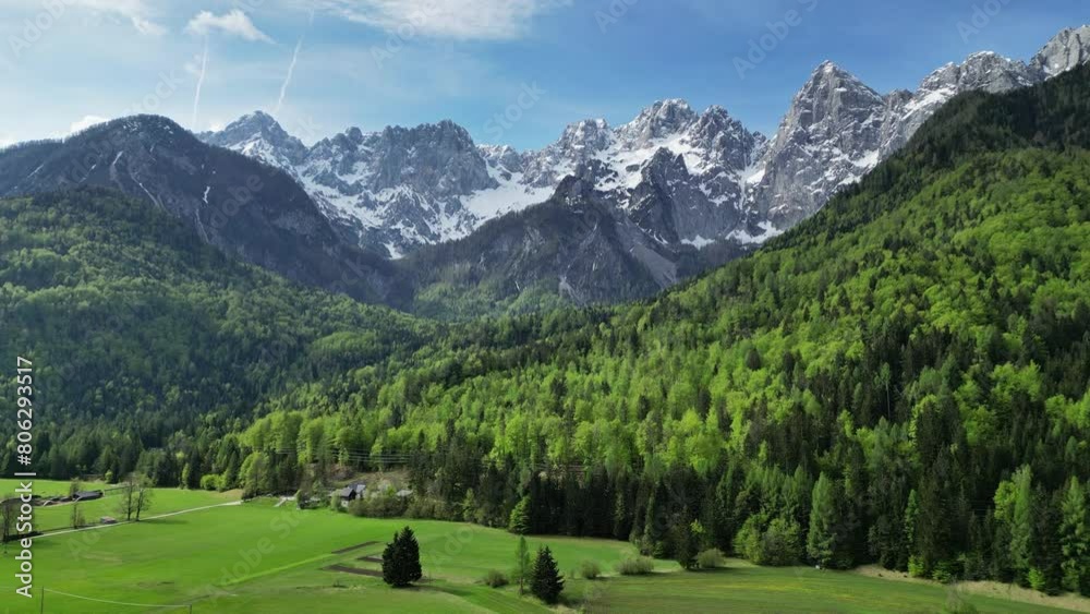 Aerial view of green pasture and breathtaking peaks of Triglav mountain ...