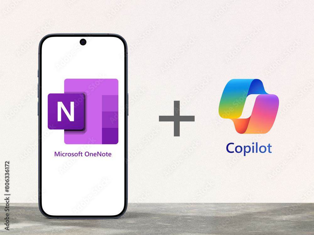 OneNote logo displayed on a modern smartphone standing on a desk ...