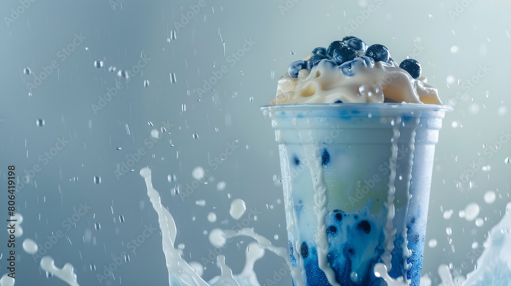 Milkshake with blue matcha, whipped cream and blueberries, in a plastic ...