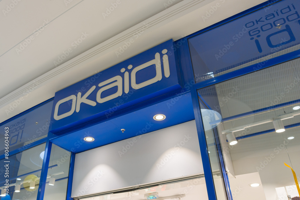 Okaidi sign logo and text brand front wall facade chain store fashion ...