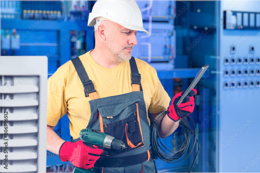 Man installer electrical equipment. Builder with screwdriver. Man ...