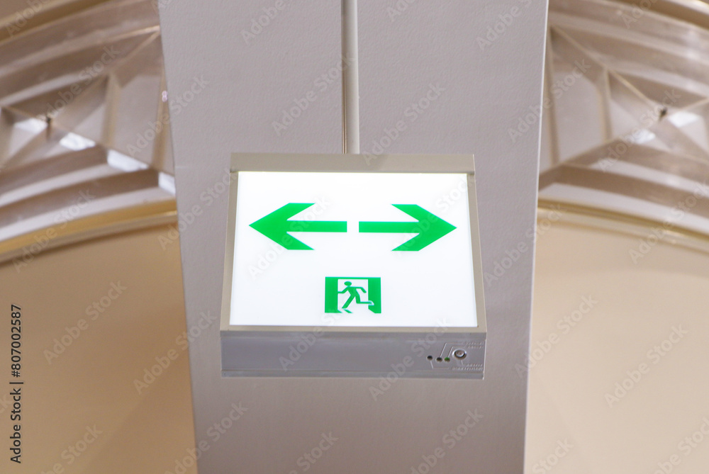 Fire exit green emergency exit signs ceiling is background. Warning ...