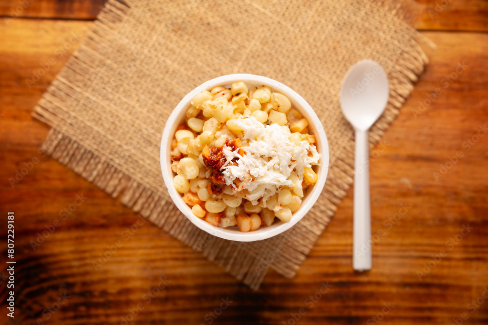 Esquites. Corn kernels cooked and served with mayo, sour cream, lemon ...