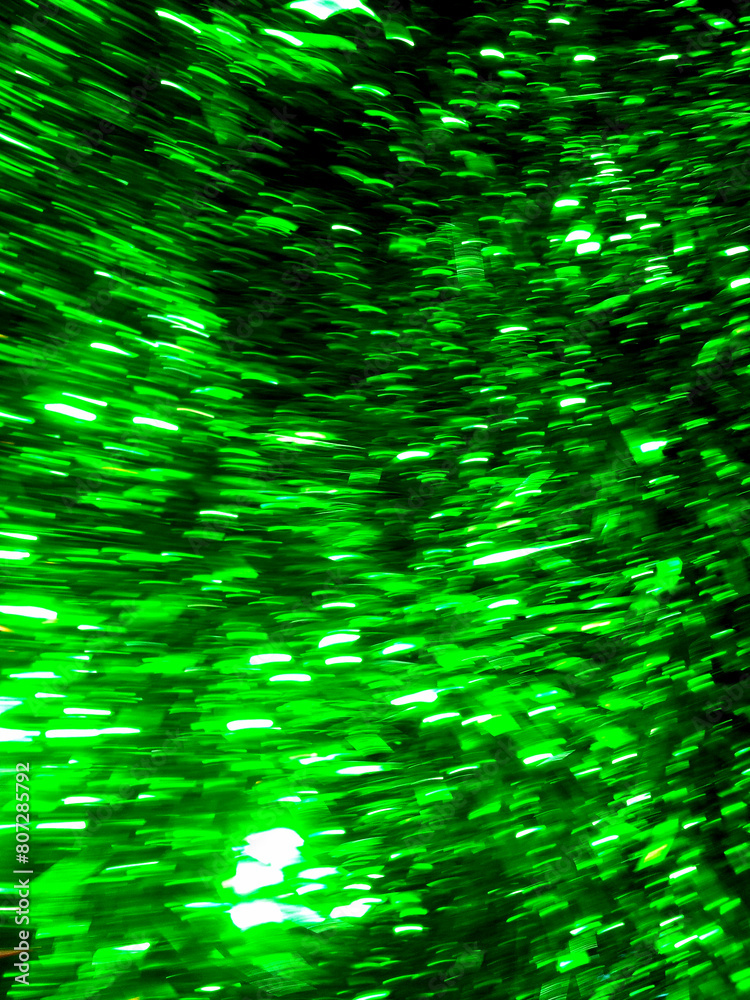 Several green bokeh light sources which are round and blurry, with some ...