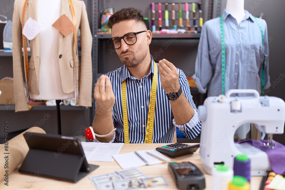 Hispanic man with beard dressmaker designer working at atelier doing ...