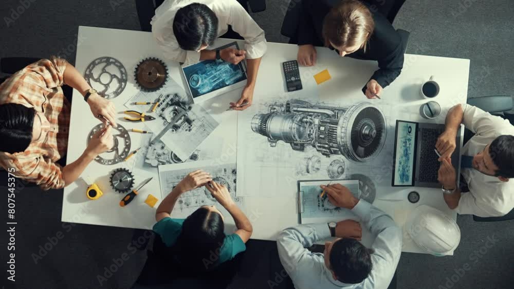 Top down aerial view of smart engineer team working together to design ...
