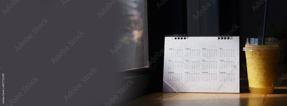 Calendar desk and iced coffee placed on business table. Desktop ...
