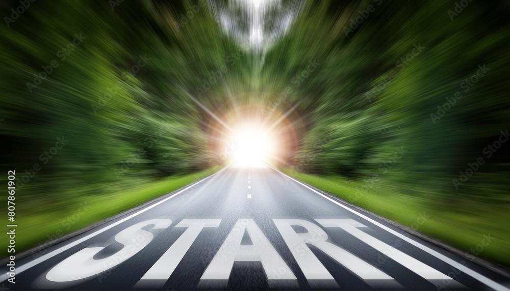 Start line on an asphalt road in the green forest with text START ...