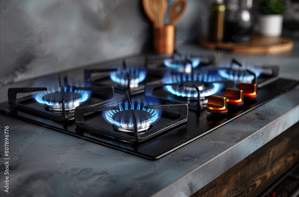 Simple gas cooker with four gas burners, little blue flame with red tip ...
