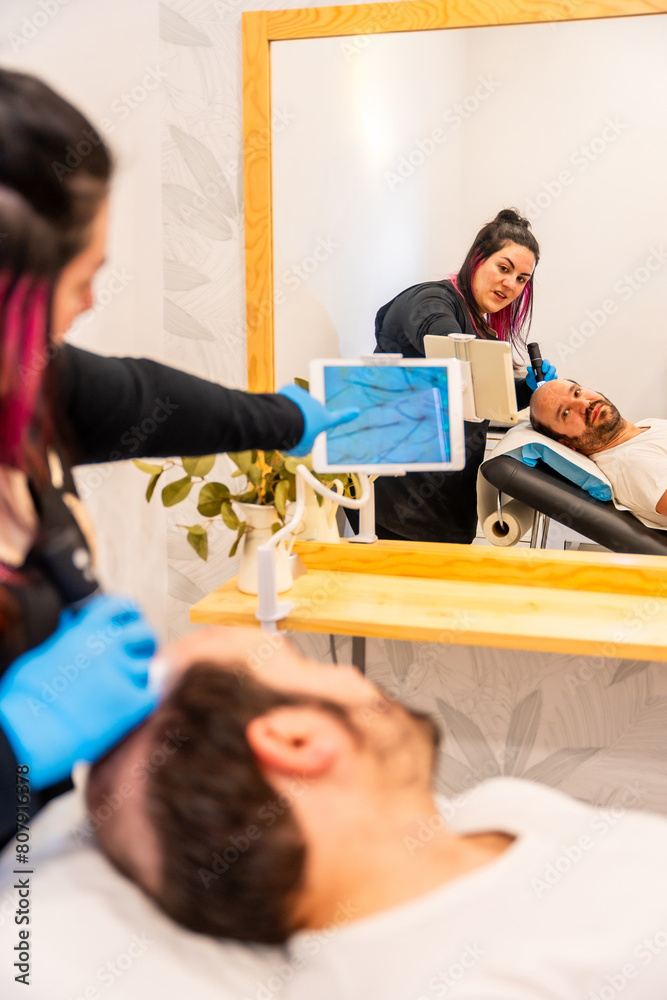 Dermatologist explaining the hair repopulation procedure to a bald ...