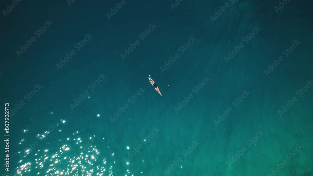 Swimmer takes a solitary journey across the sea. Human in ocean ...