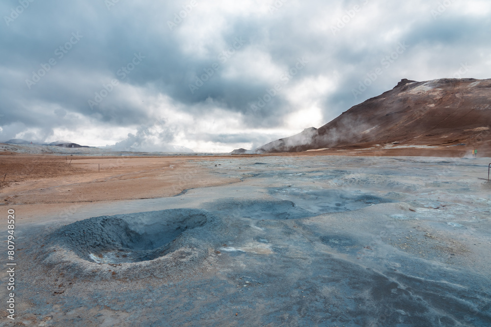 Námafjall Geothermal Area. Tourists in the distance, steaming fumaroles ...