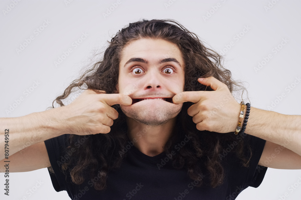 Man, portrait and crazy face in studio for emoji, comedy and comedy by ...