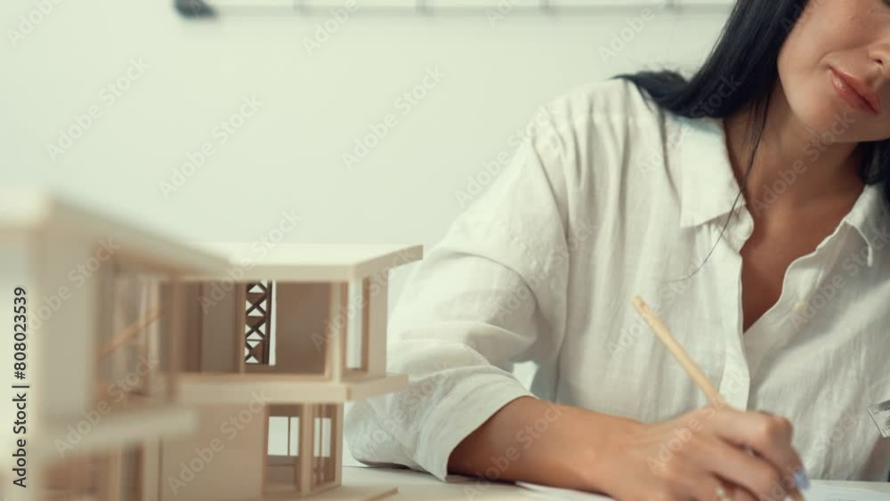 Closeup of beautiful young architect engineer focus on using pencil ...