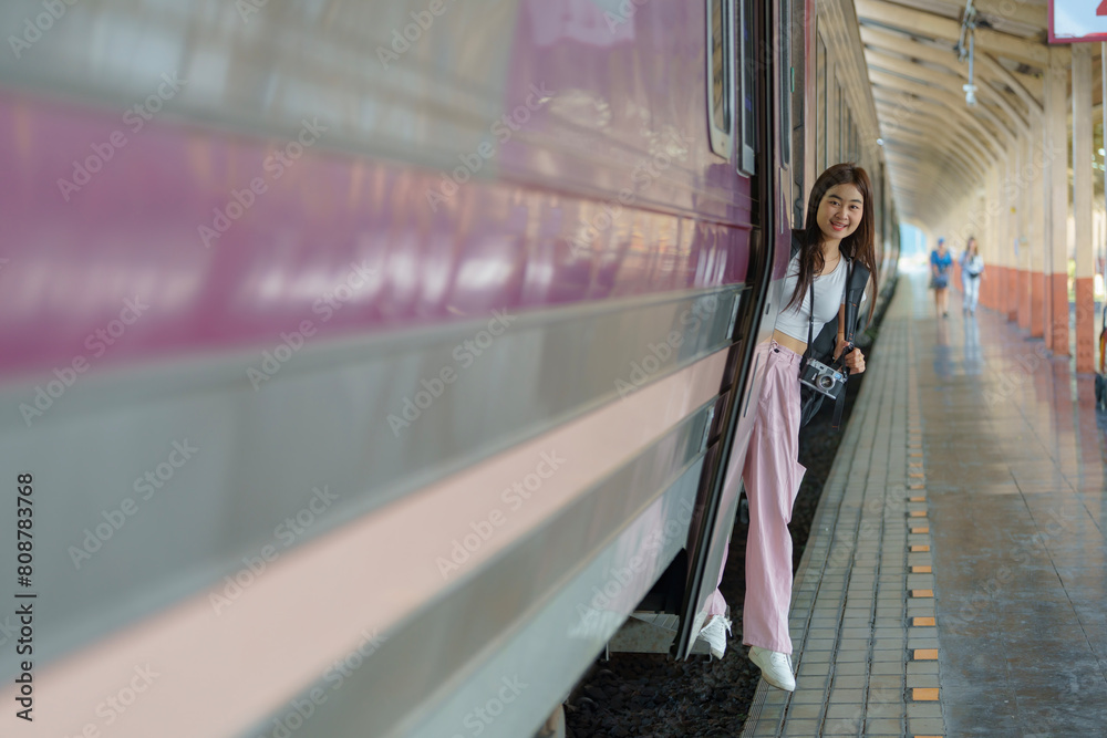Asian woman traveler getting on a train to hop on a train, Young woman ...