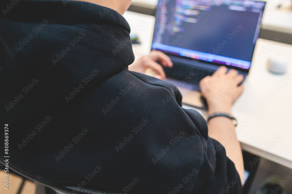 Software developer students in auditorium hall working on computer and laptop, programming ...