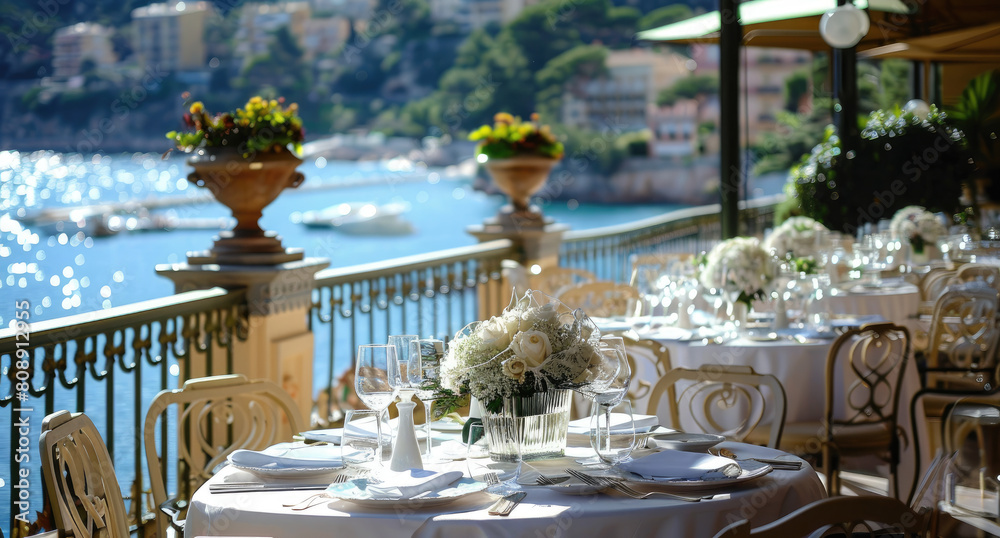 Dining tables were set up on the terrace of an elegant restaurant with ...