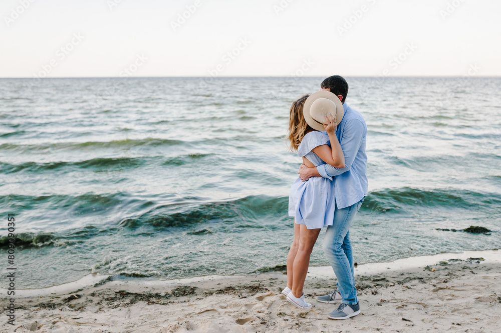 Hat hidden face. Female and male hide faces behind straw hat and kiss ...