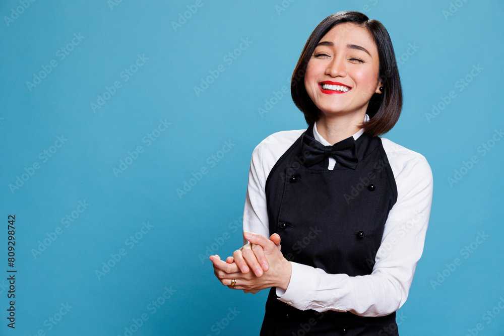 Smiling cafe waitress applauding with joy and encouragement, showcasing ...