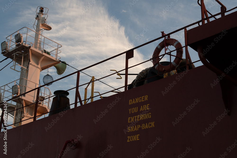 forecastle head area of cargo ship with warning text of snap back ...