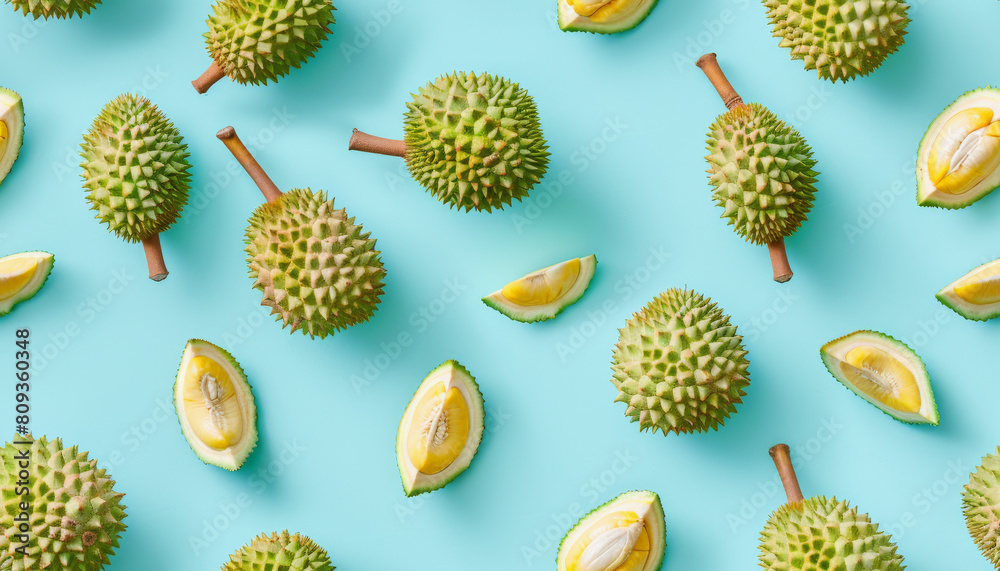 Several whole and sliced durians with their unique spiky exterior and ...