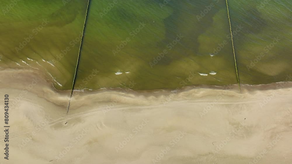 Top-down aerial view capturing the intersection of a sandy beach and ...