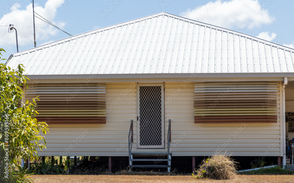 A small farmhouse with tin roof and interestingly charming window ...