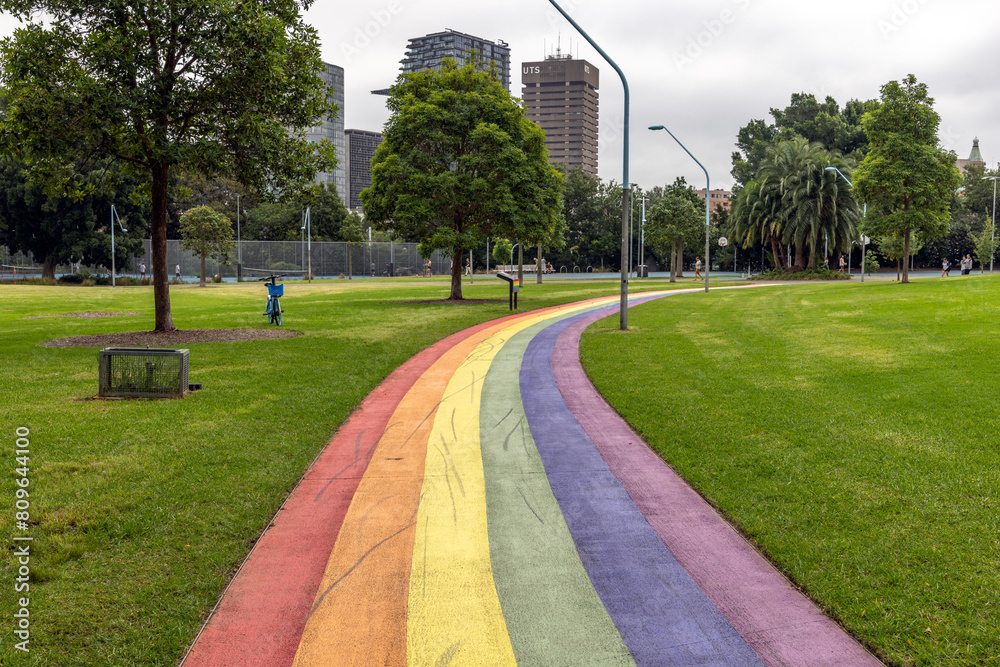 Landscape view with a rainbow coloured path, winding through a public ...