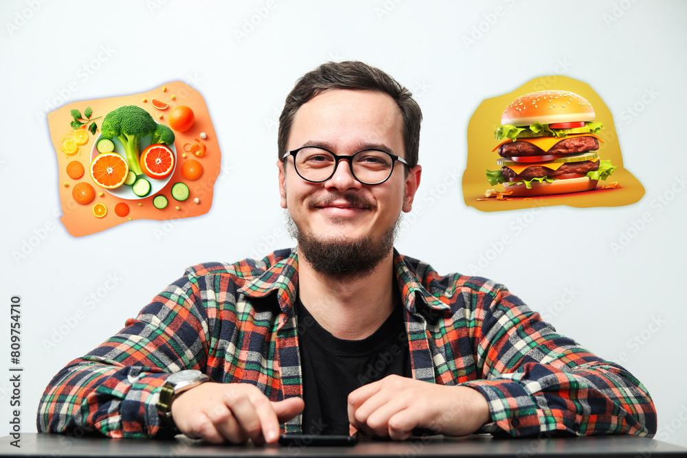 Good and bad food. Choose between healthy and junk food.Young man, food ...