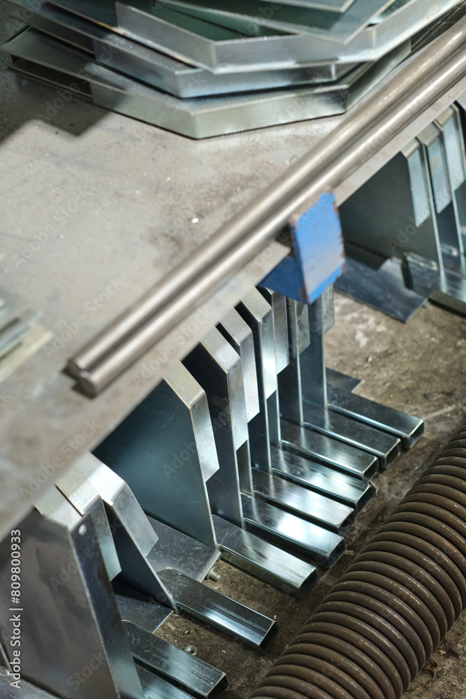 Metal steel square piping pipes stacked up on an industrial heavy duty ...
