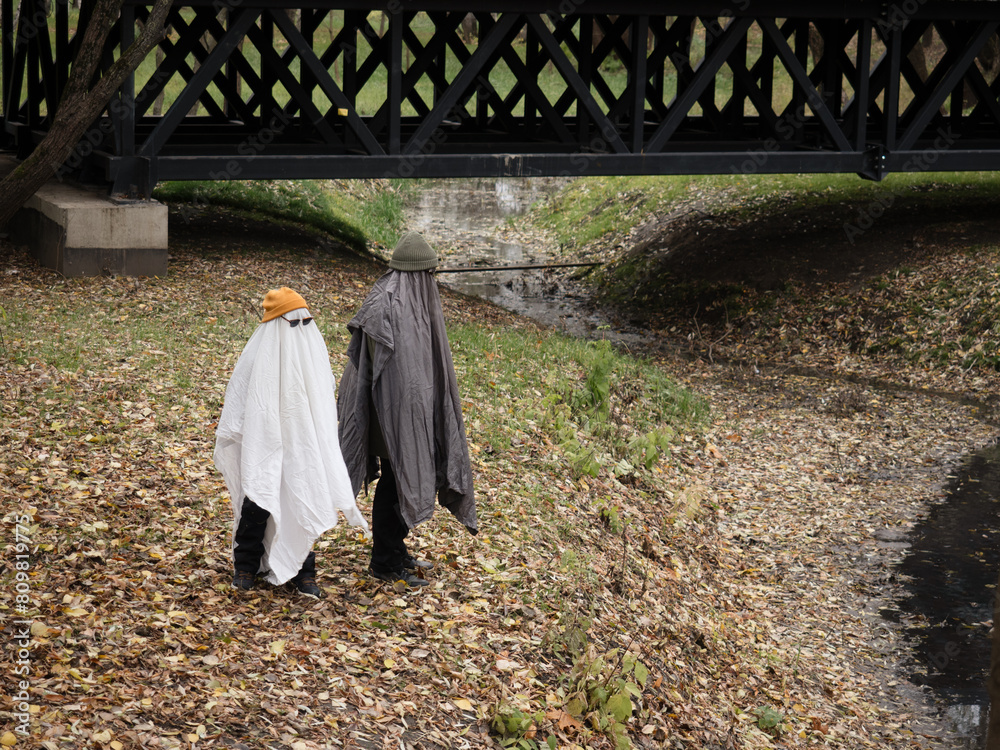 Two boys dressed as ghosts in grey and white sheets, Halloween ...