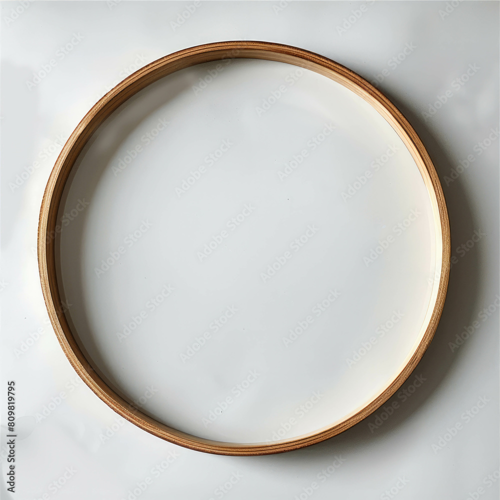 Minimalist design: thin light-colored circular wooden frame on a white ...