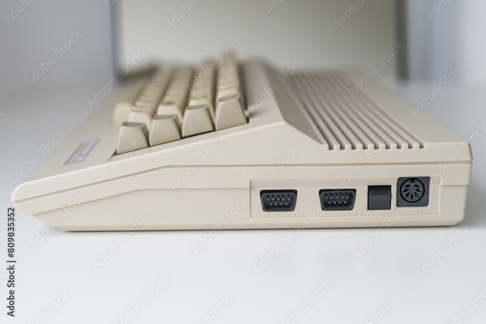 Poster A side view of a vintage computer with visible ports ...