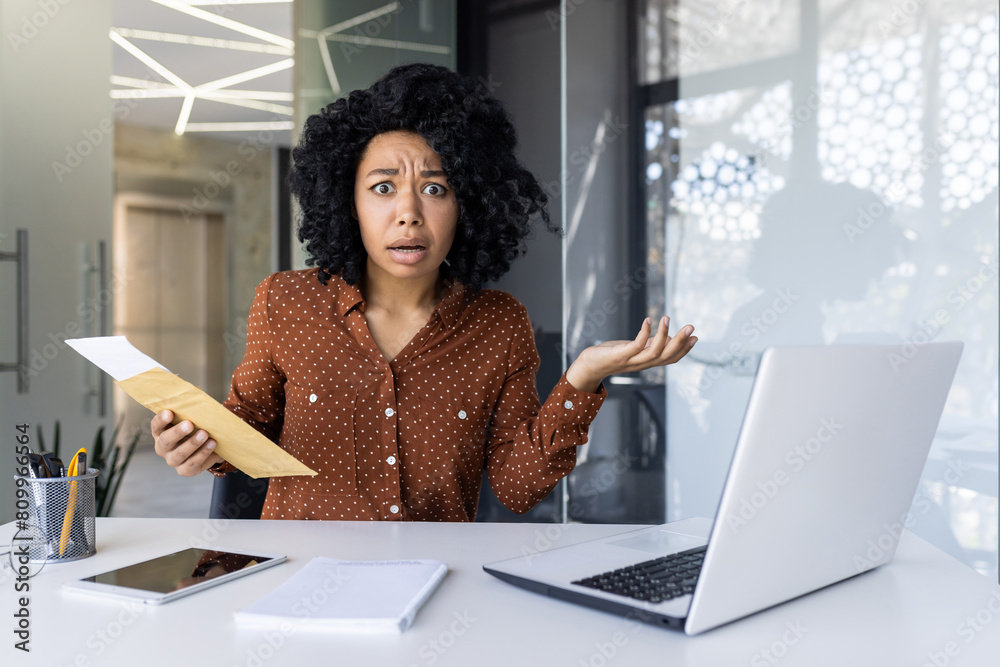 African American businesswoman appears shocked and distressed as she ...
