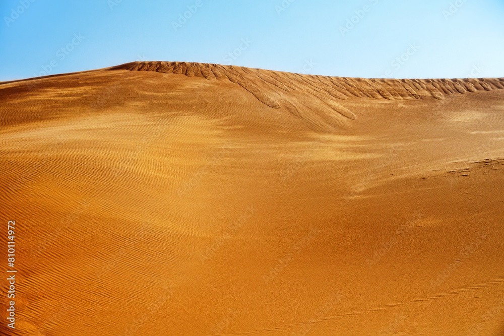 Sand fall. Sand landslide from the crest of a red dune (iron oxide) as ...