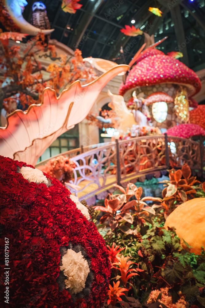 Vibrant whimsical indoor scene with large red mushroom structure adorned with flowers in Las ...