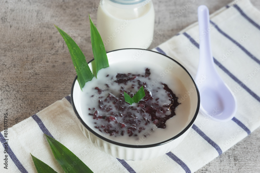 Black sticky rice porridge, a typical Indonesian dessert. Black sticky ...