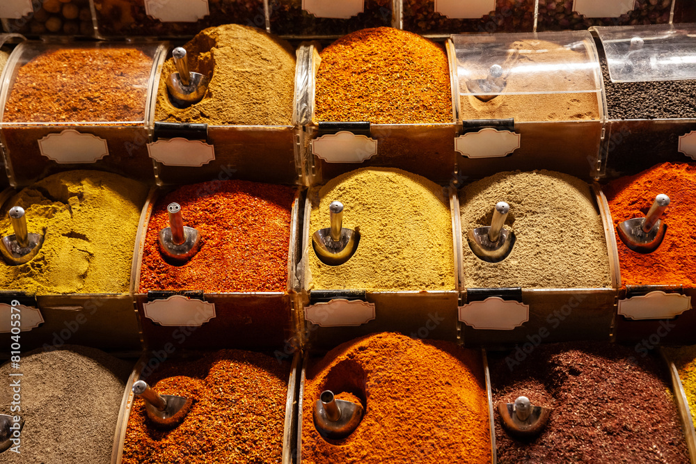 Selective blur on piles of spices of various colors and tastes, used in ...