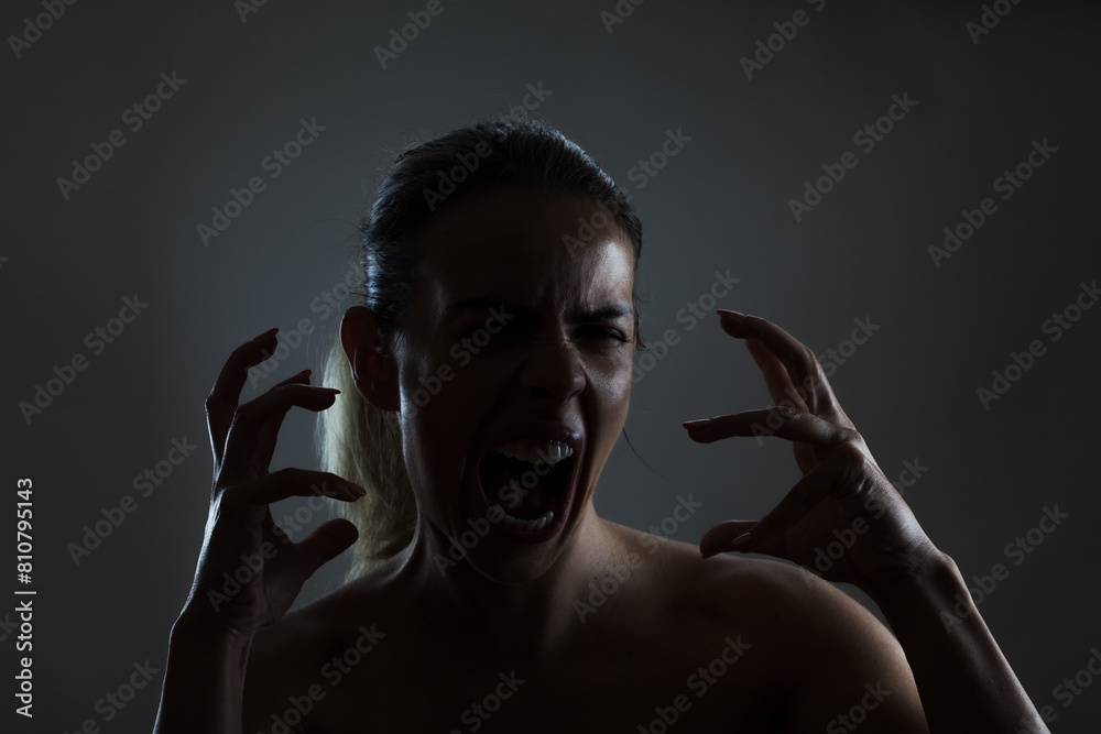 Expressive woman screaming powerfully, showing raw emotion and ...
