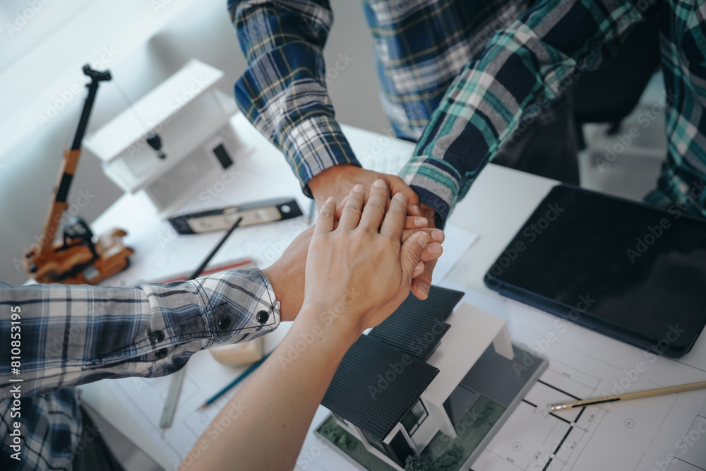 Engineers shaking hands, teamwork in meetings, drawing blueprints for ...