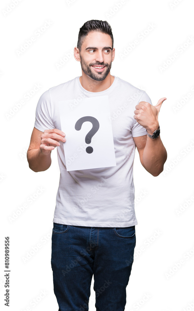 Handsome young man holding paper with question mark over isolated ...