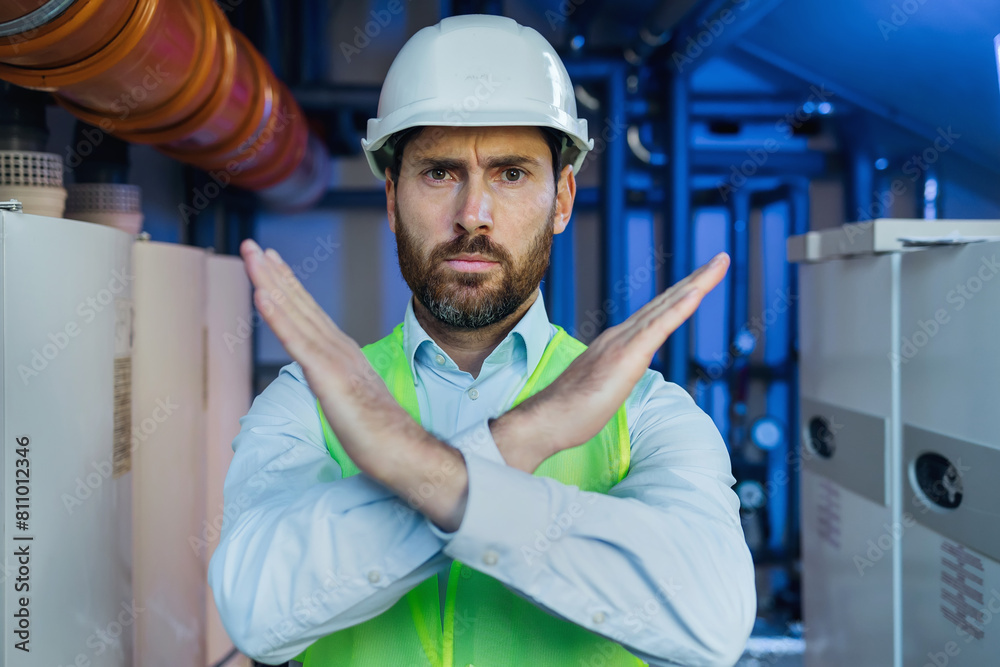 Electrical engineer technician in protective vest and white helmet ...