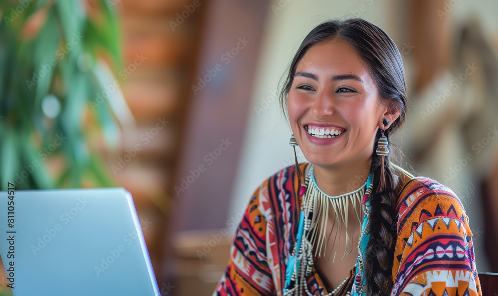 Happy Native American Indian woman working remotely at laptop at home ...
