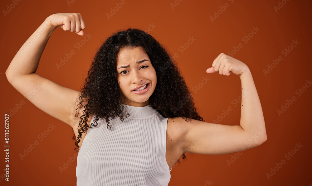Bicep, flex and portrait of powerful woman in studio isolated on brown ...