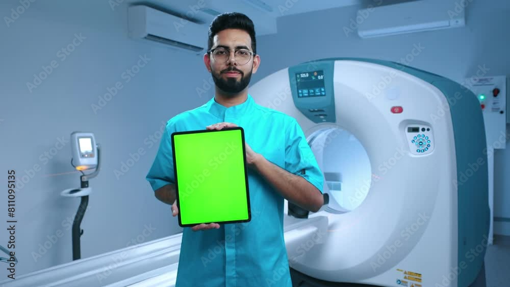 Indian tomography specialist showing tablet with chroma key screen ...