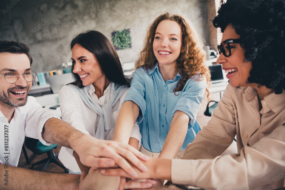 Portrait of group professional corporate workers smile pile stack hands ...